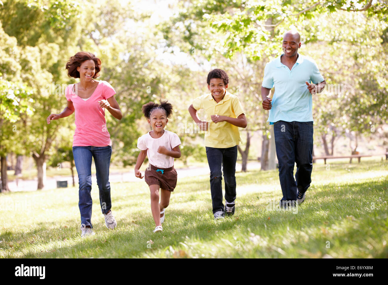 Family running in park Stock Photo - Alamy