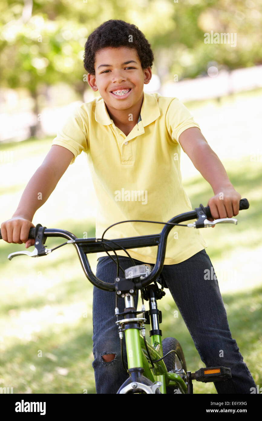 Boy cycling in park Stock Photo - Alamy