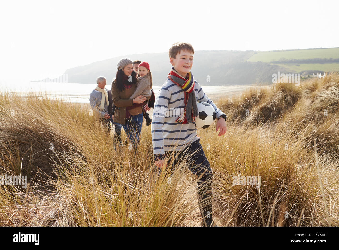 Multi Generation Family In Sand Dunes On Winter Beach Stock Photo - Alamy