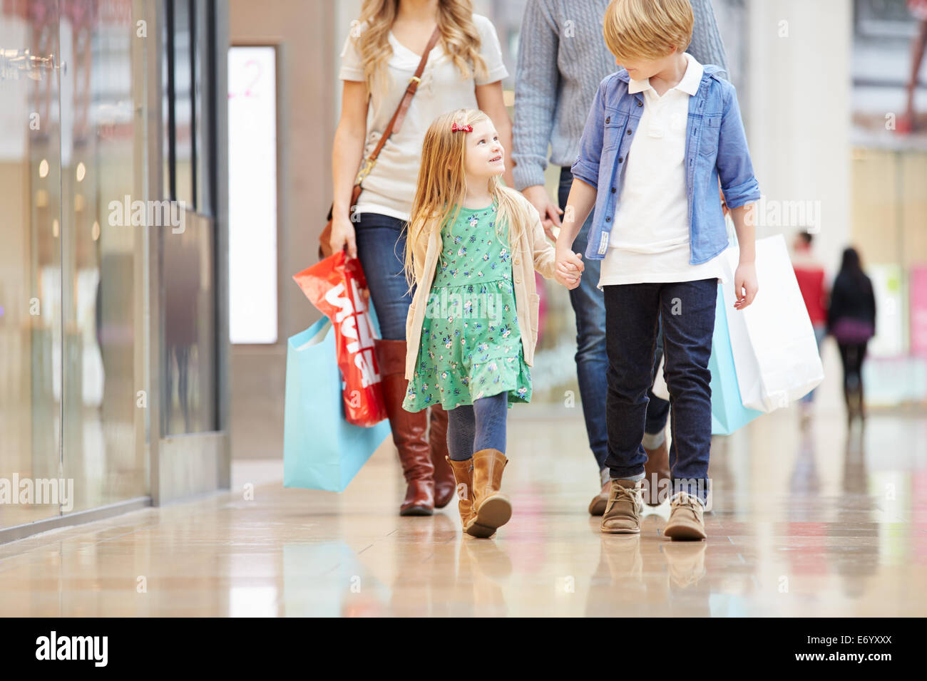 Child holding hands parents mall hi-res stock photography and images ...