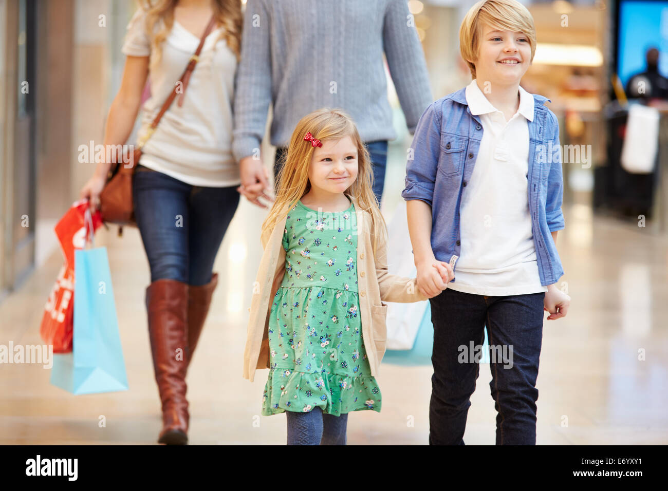 Children On Trip To Shopping Mall With Parents Stock Photo - Alamy