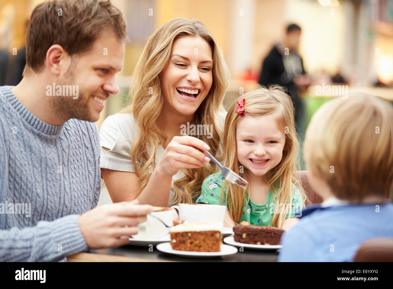 Family Enjoying Snack In Café Together Stock Photo - Alamy