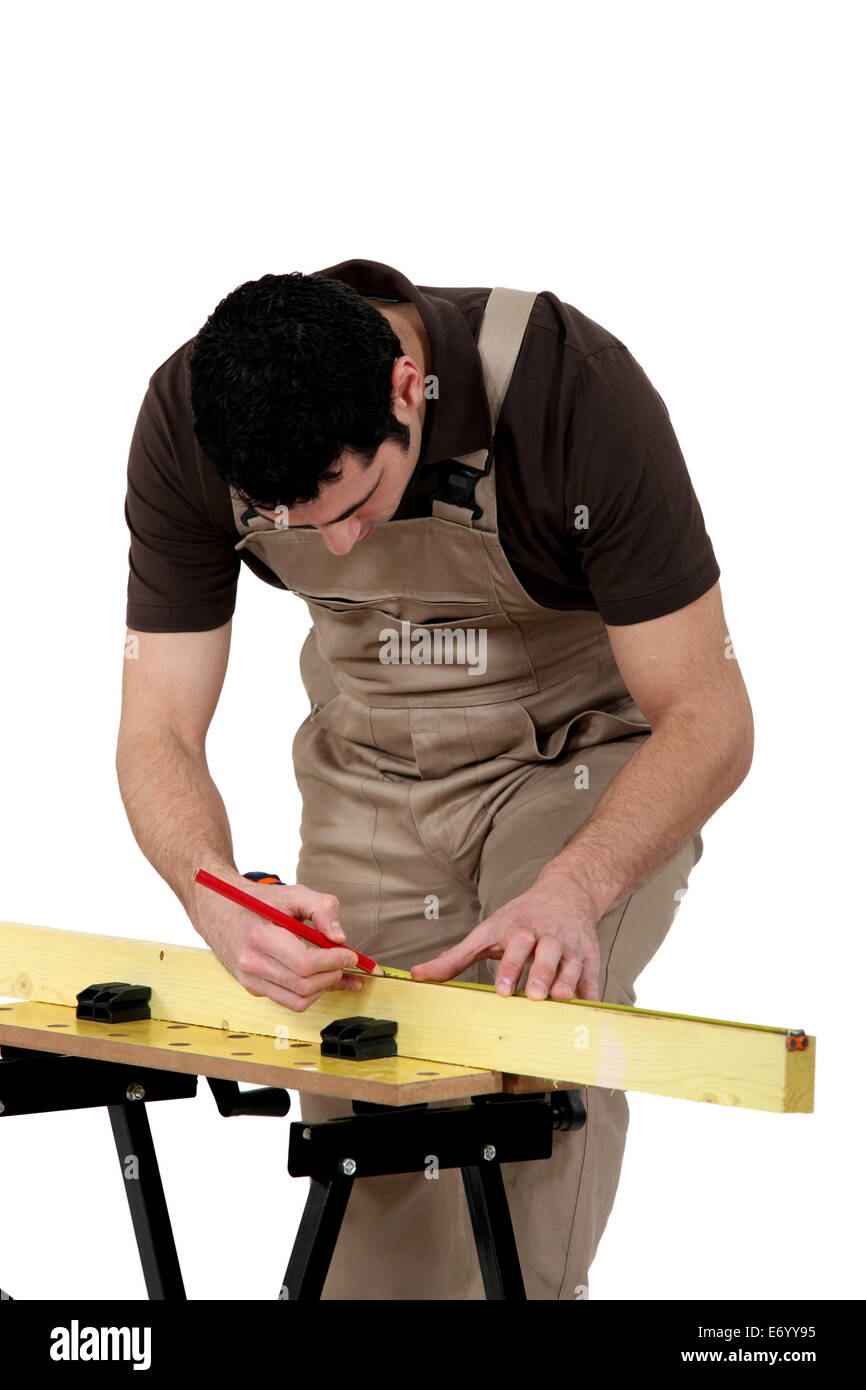 Man measuring wooden plank Stock Photo - Alamy