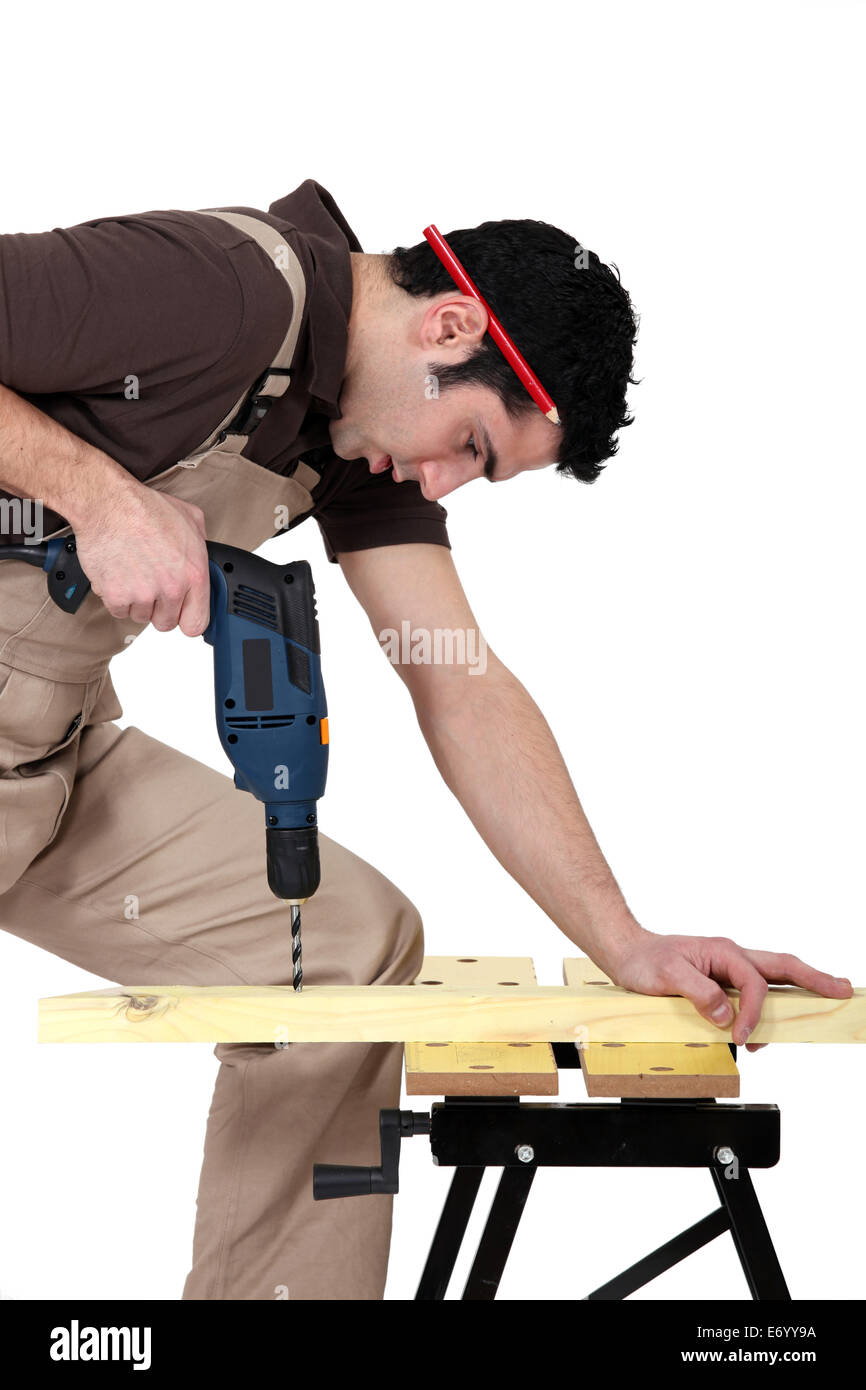 Carpenter drilling a piece of wood Stock Photo - Alamy