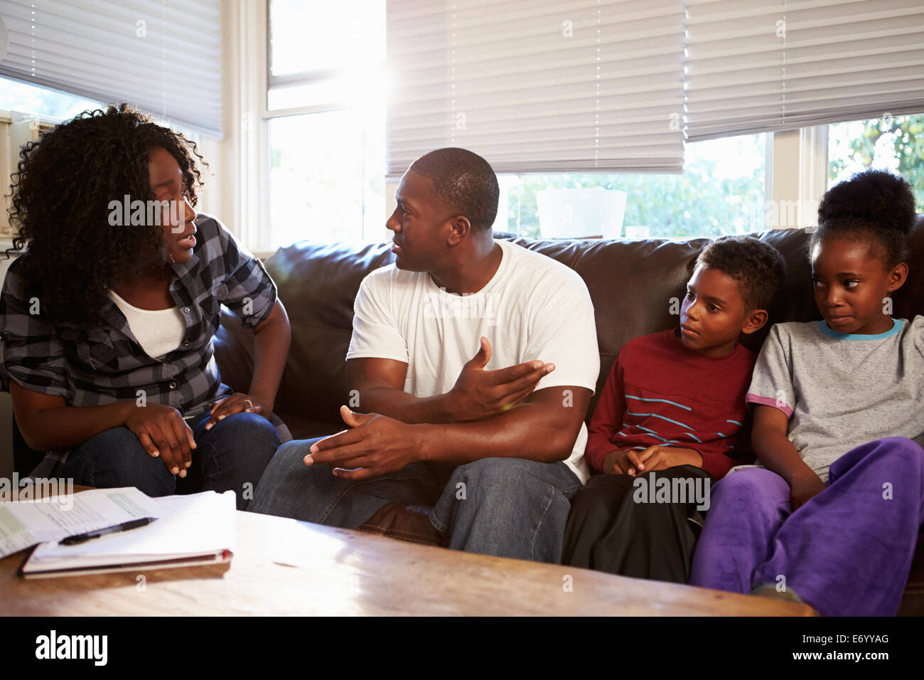 Family Sitting On Sofa With Parents Arguing Stock Photo - Alamy