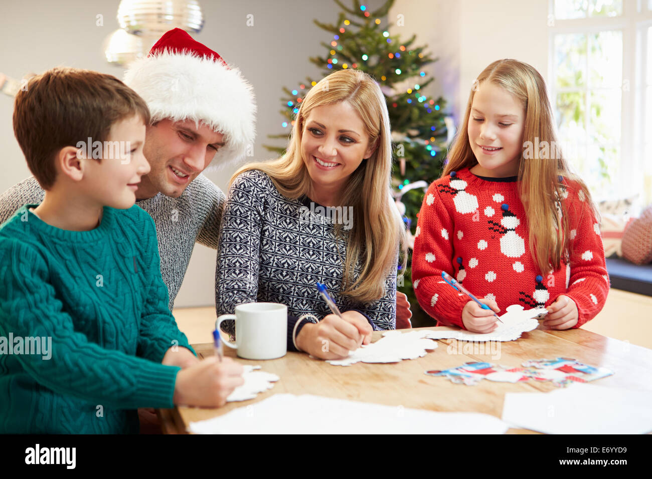 Family Writing Christmas Cards Together Stock Photo - Alamy