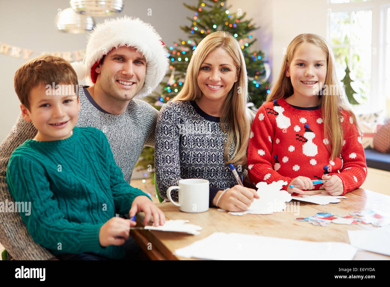 Family Writing Christmas Cards Together Stock Photo - Alamy