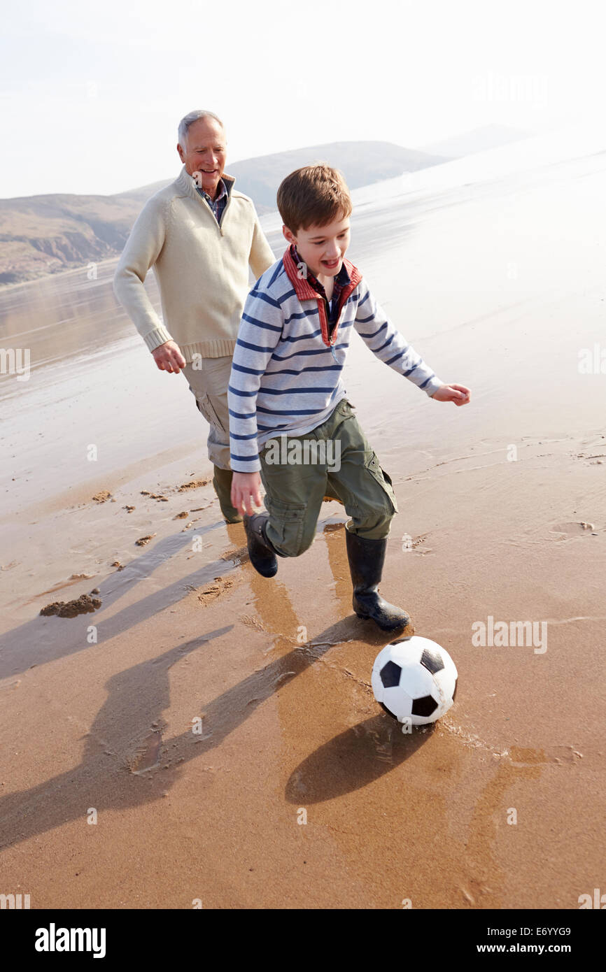 Grandfather And Grandson Playing Football On Winter Beach Stock Photo ...