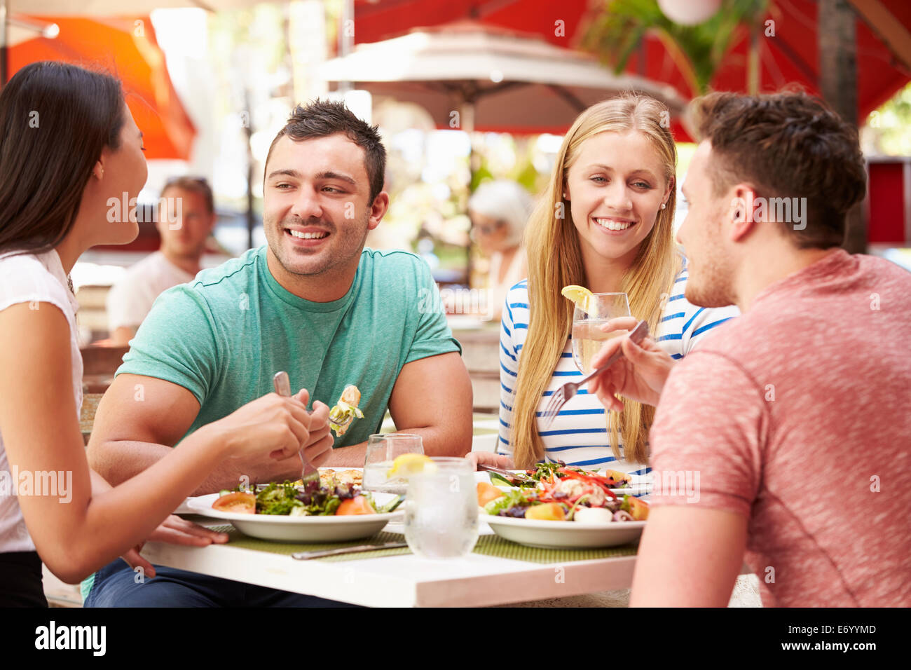 Group Of Friends Enjoying Lunch In Outdoor Restaurant Stock Photo - Alamy