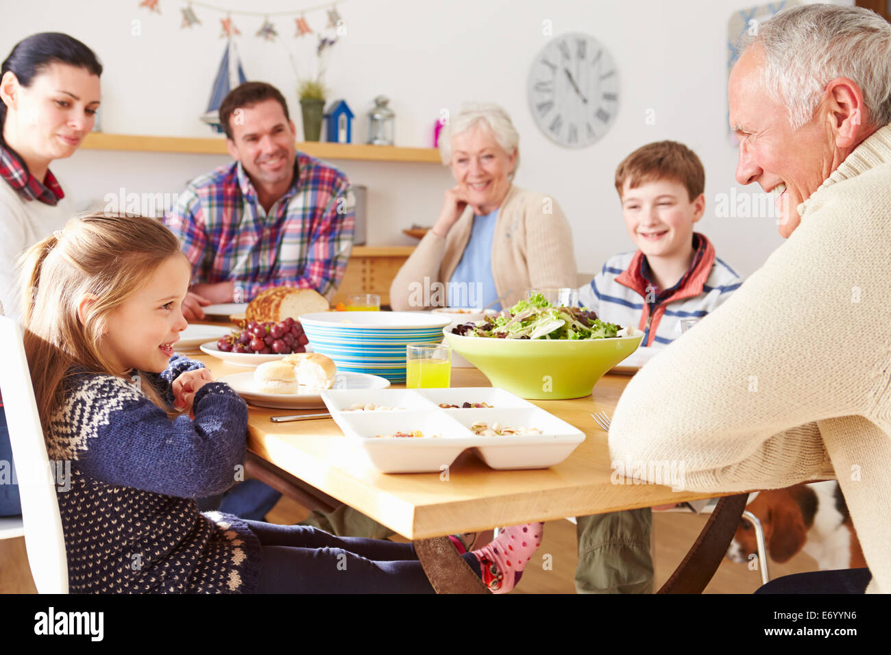 Multi Generation Family Eating Lunch At Kitchen Table Stock Photo - Alamy