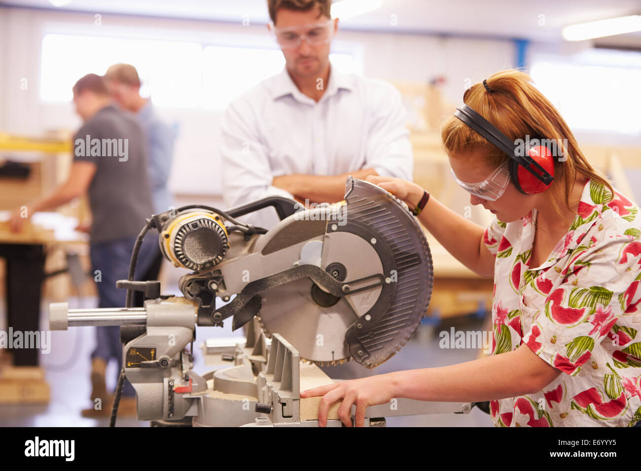 Student And Teacher In Carpentry Class Using Circular Saw Stock Photo ...