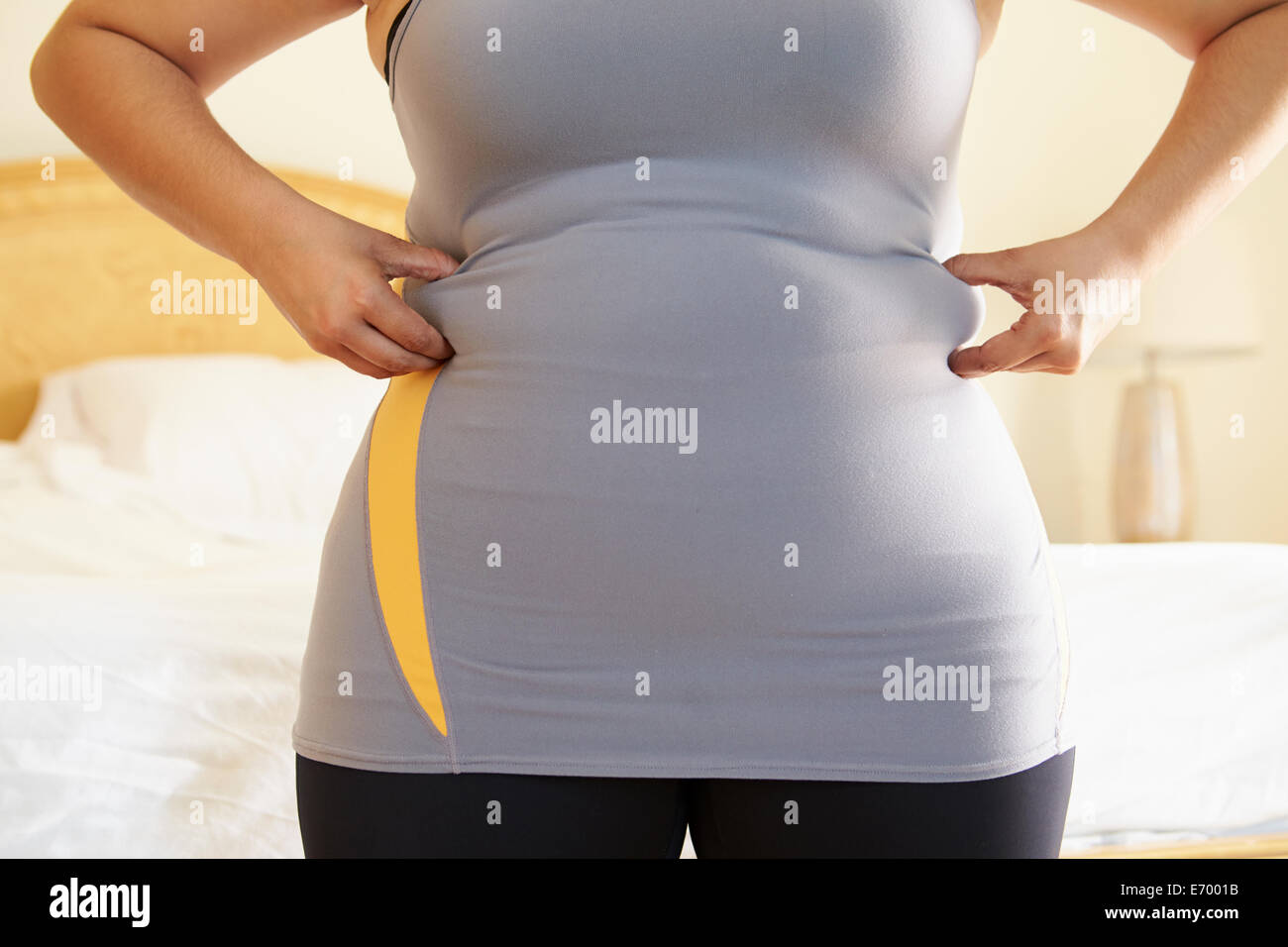 Close Up Of Overweight Woman Squeezing Waistline Stock Photo - Alamy