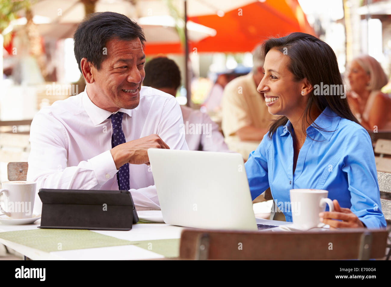 Two men two women having business meeting in cafe hi-res stock ...