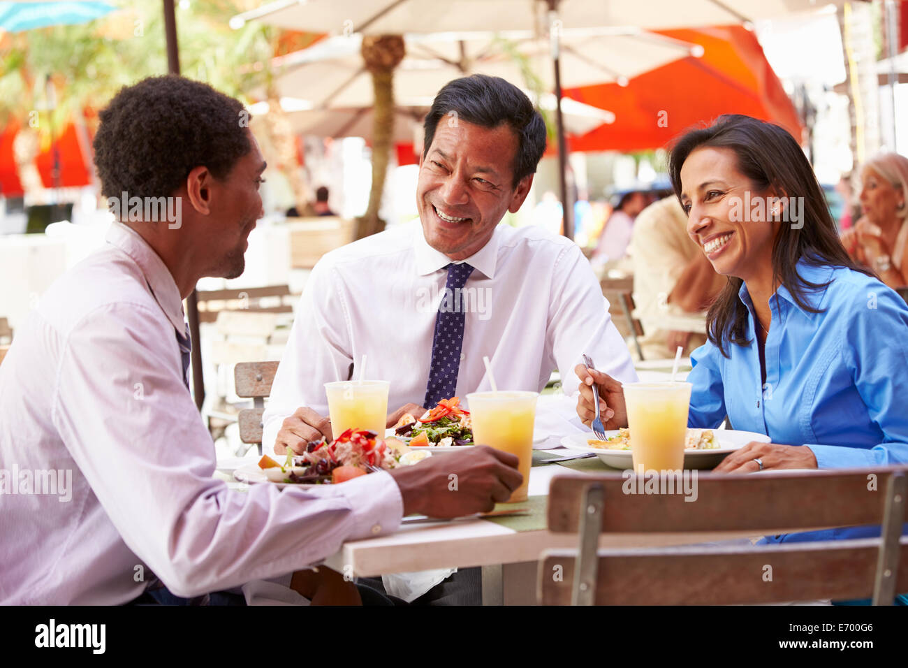 Three Businesspeople Having Meeting In Outdoor Restaurant Stock Photo ...