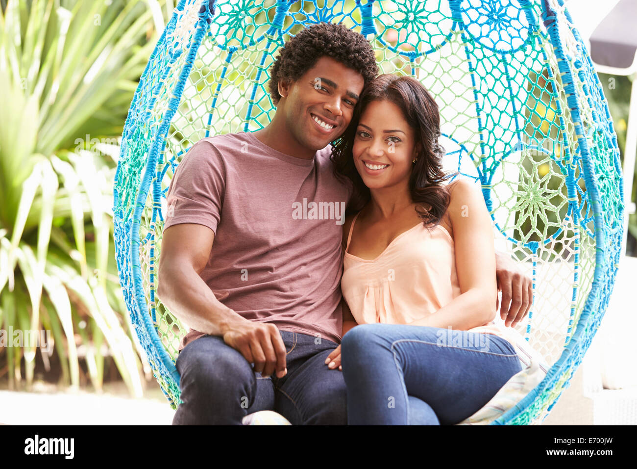 Couple Relaxing On Outdoor Garden Swing Seat Stock Photo - Alamy