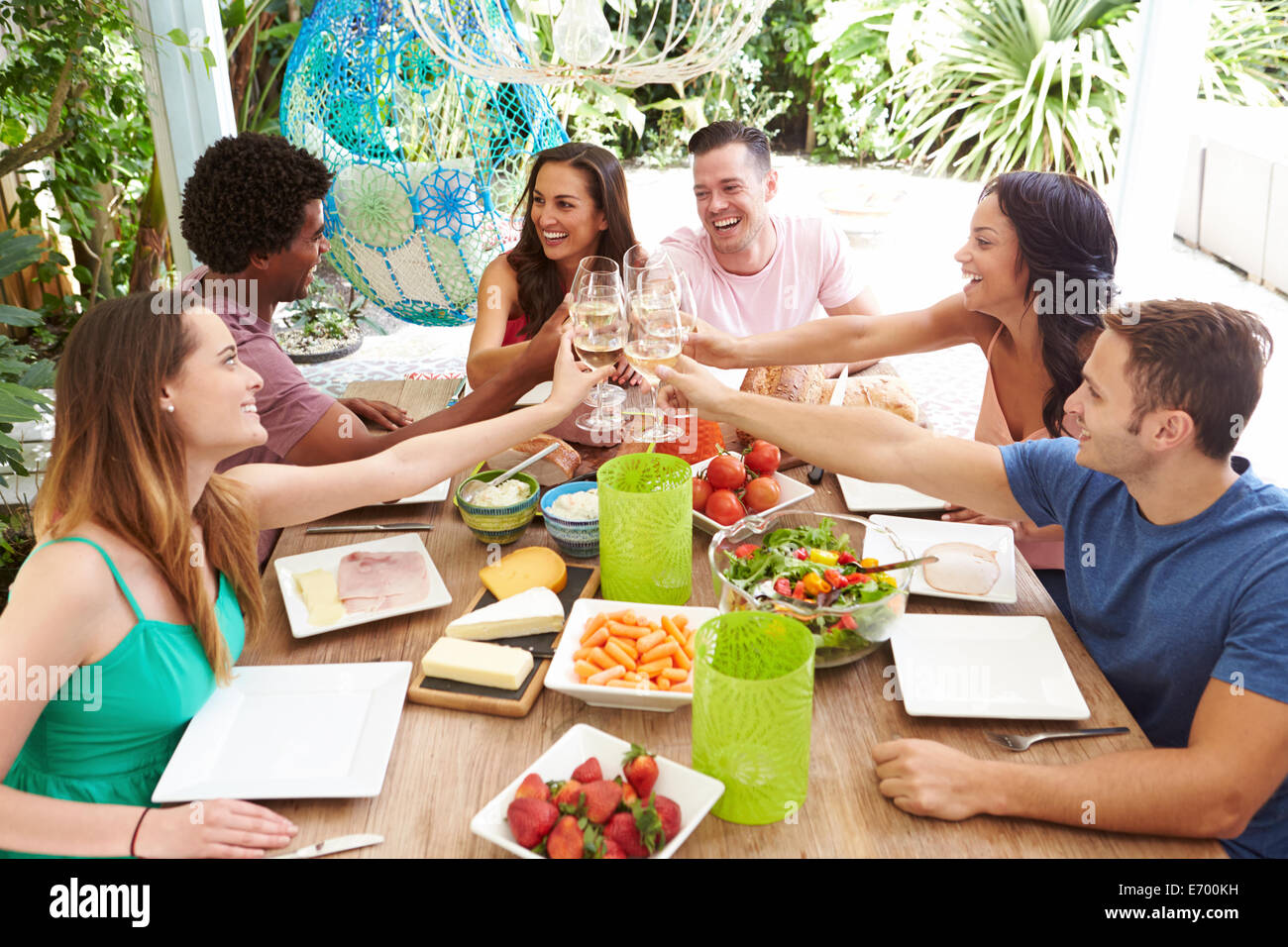 Group Of Friends Enjoying Meal Outdoors At Home Stock Photo - Alamy