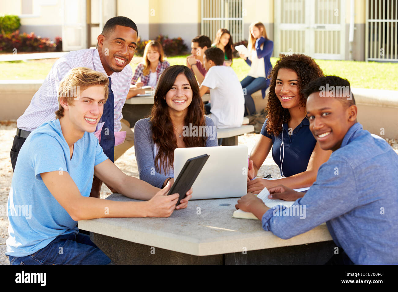 High School Students Working On Campus With Teacher Stock Photo - Alamy