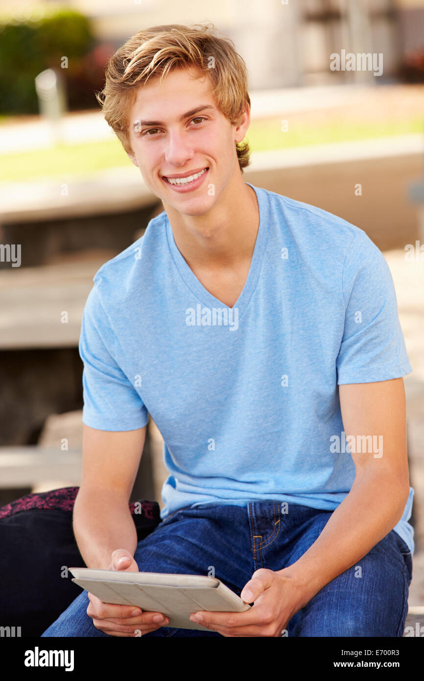 Male High School Student Using Digital Tablet Outdoors Stock Photo - Alamy