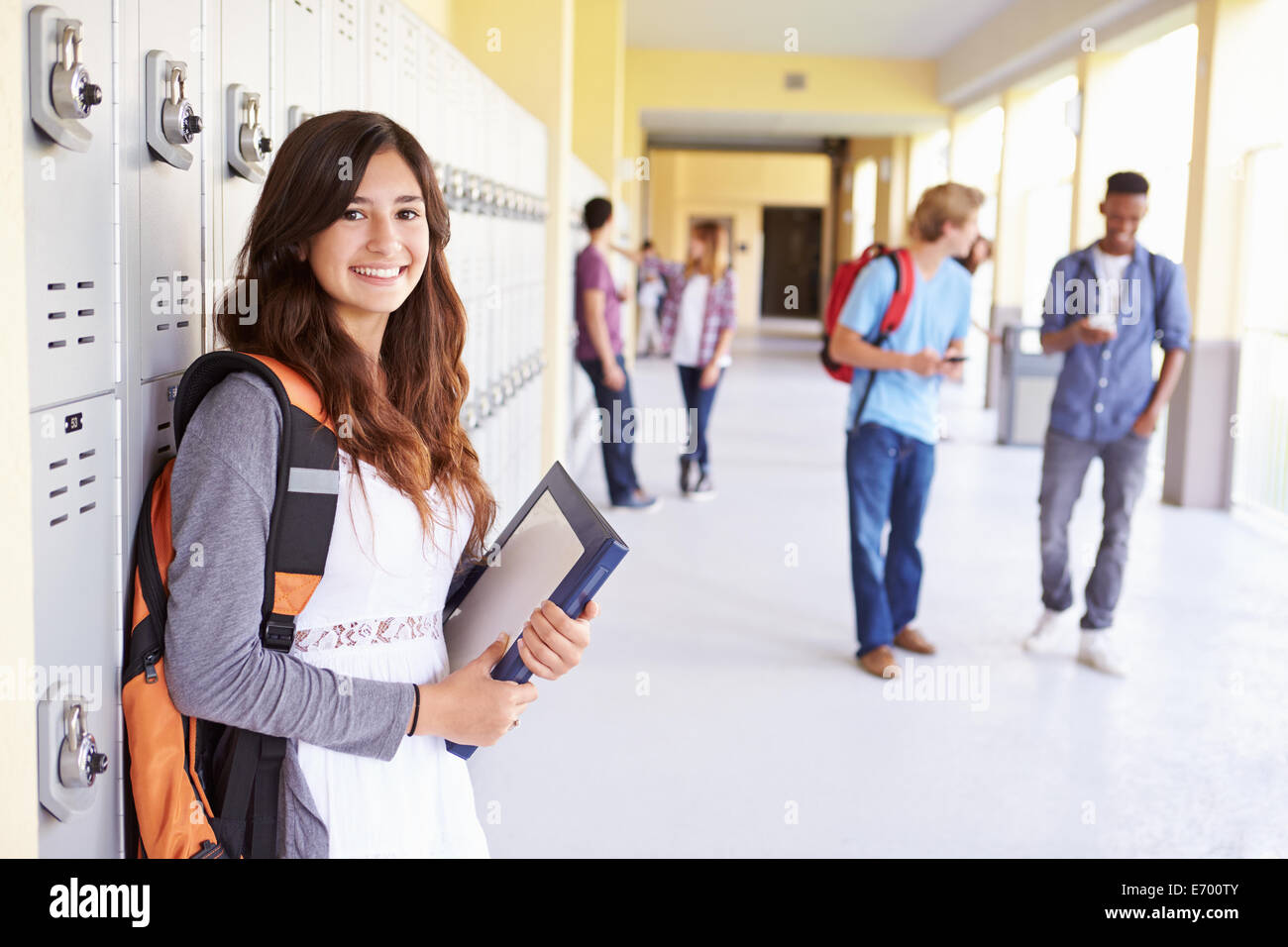 Female High School Student Standing By Lockers Stock Photo - Alamy