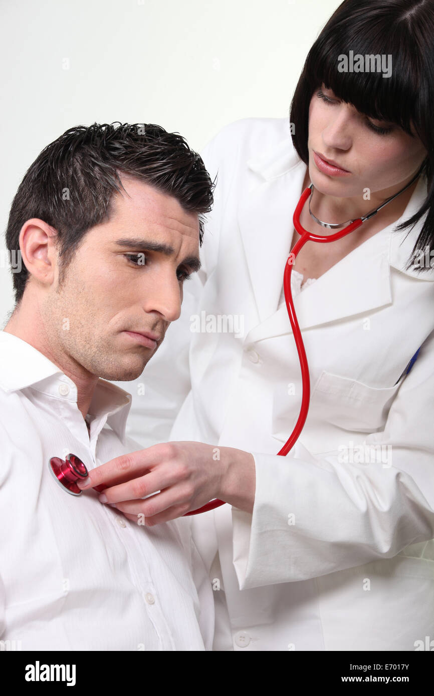 Doctor auscultating patient Stock Photo - Alamy