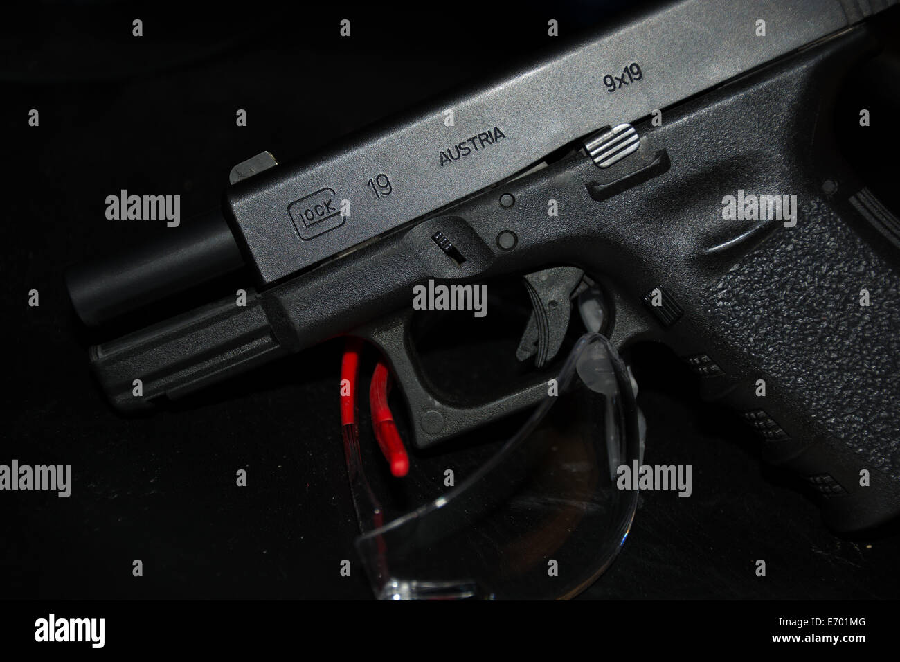 Glock 19 on clear lens glasses Stock Photo - Alamy