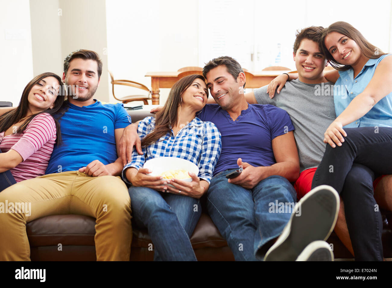 Group Of Friends Sitting On Sofa Watching TV Together Stock Photo - Alamy