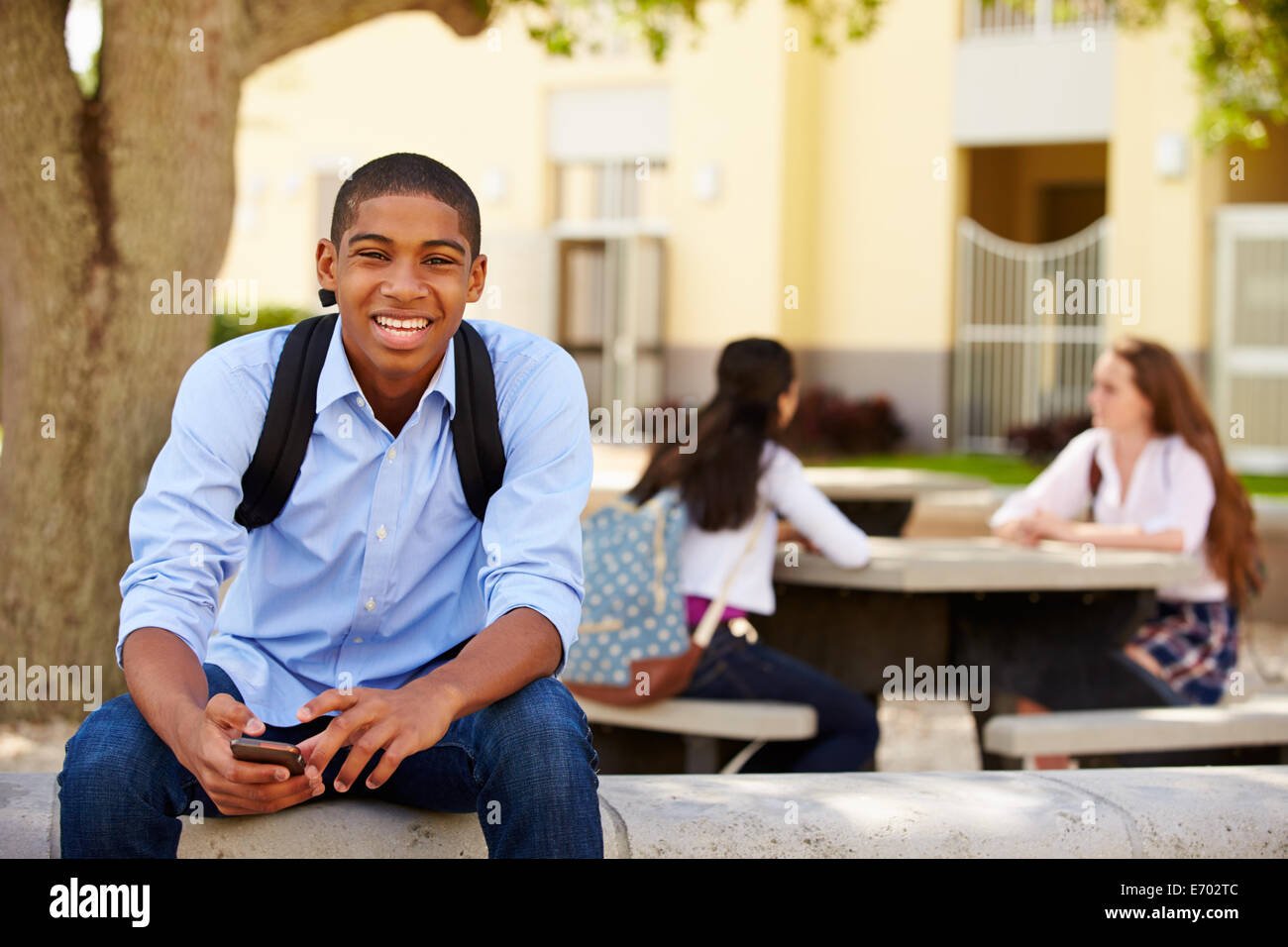 Male High School Student Using Phone On School Campus Stock Photo - Alamy