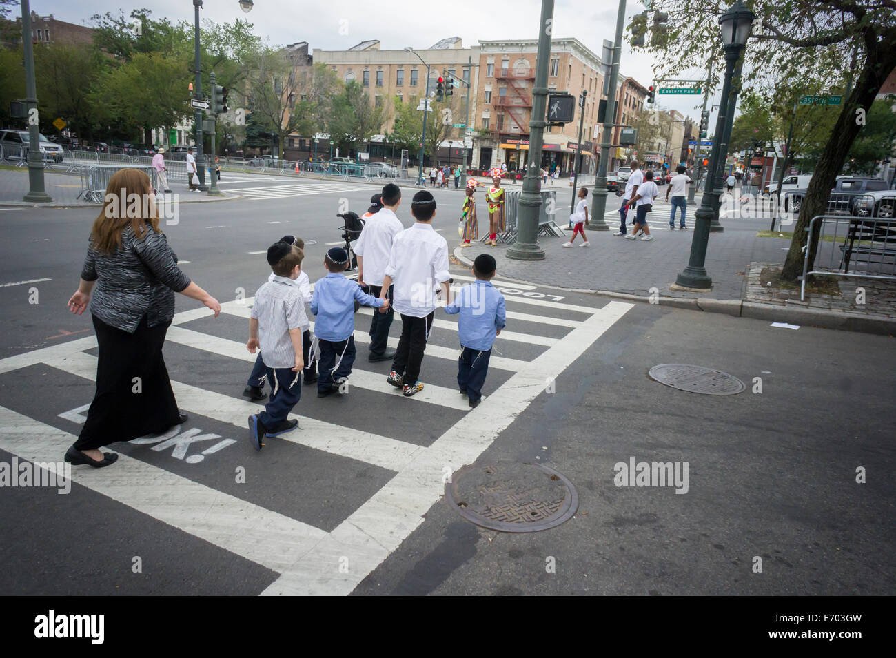 An Orthodox Jewish family crosses Eastern Parkway in the neighborhood ...