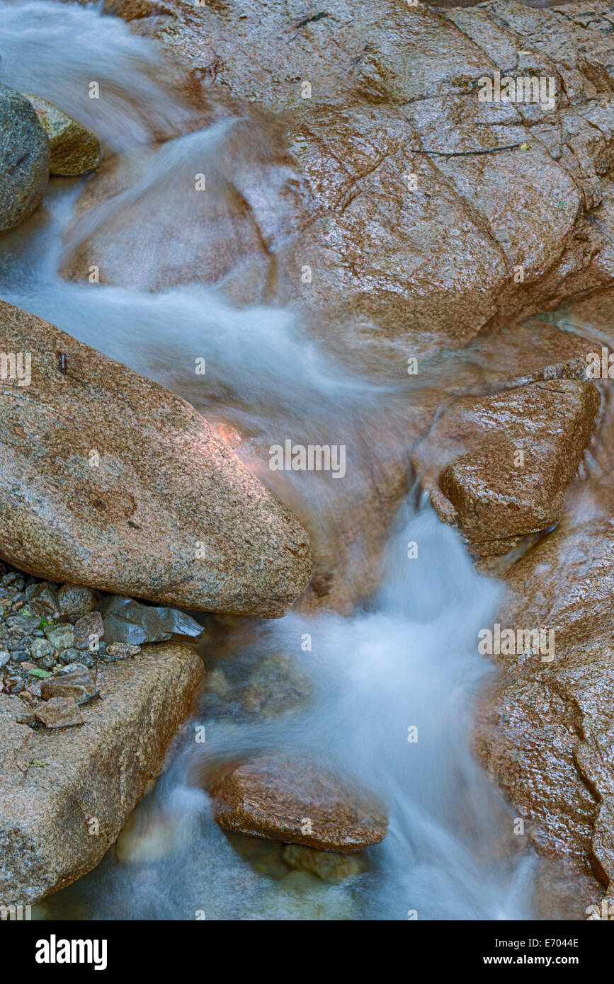 Water rushes across stone, smoothing and shaping the rock, carving a ...