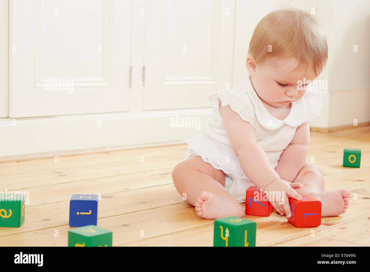 Baby girl playing with blocks hi-res stock photography and images - Alamy