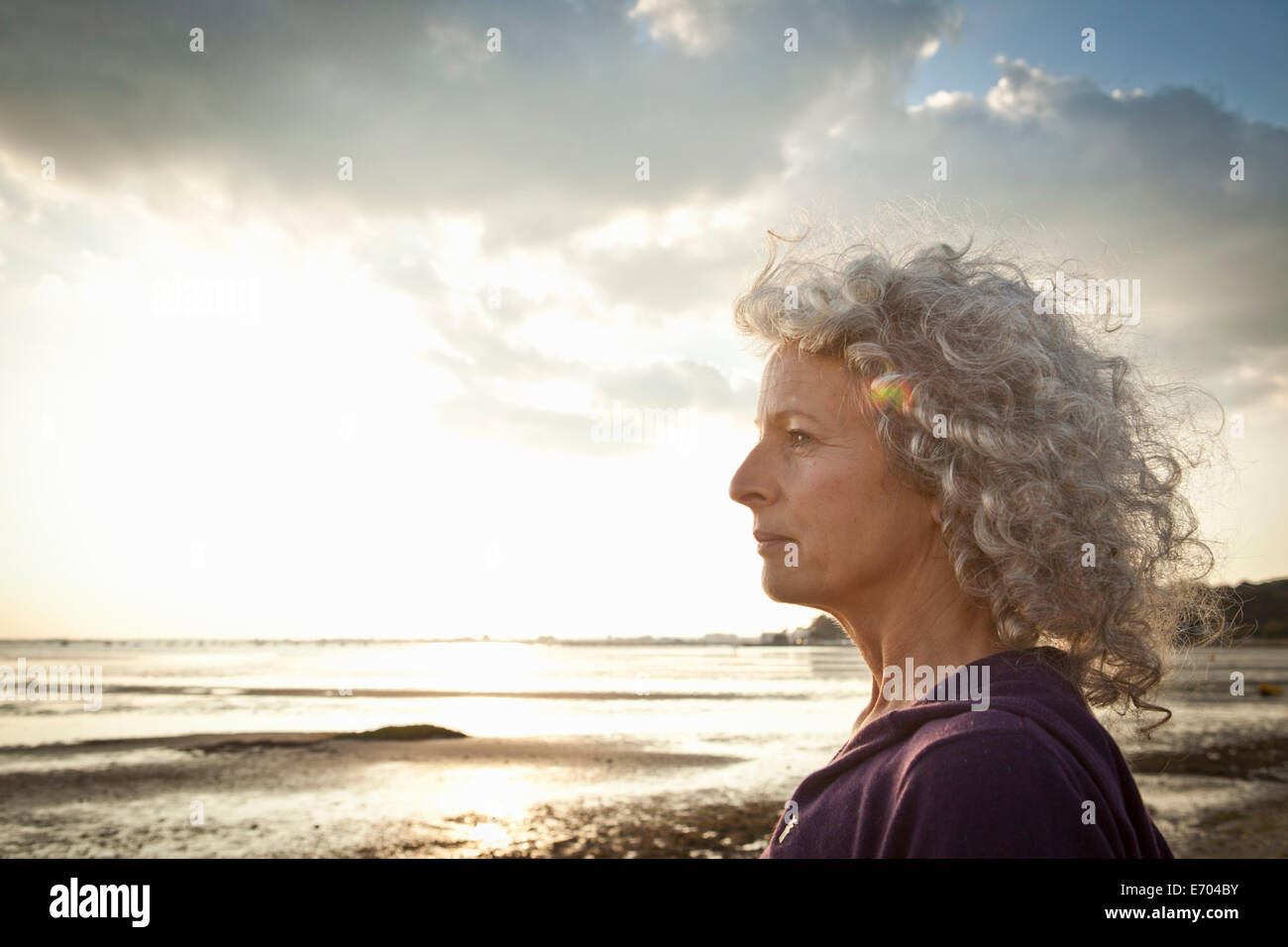 Mature woman enjoying peaceful sunset hi-res stock photography and ...