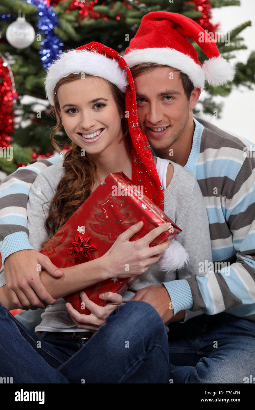Couple by a Christmas tree Stock Photo - Alamy