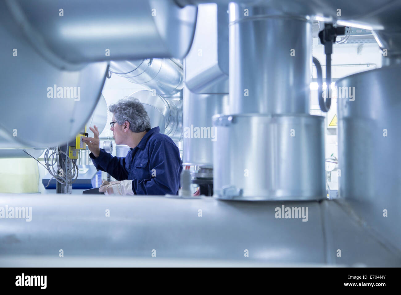 Engineer adjusting control panel in power station Stock Photo - Alamy
