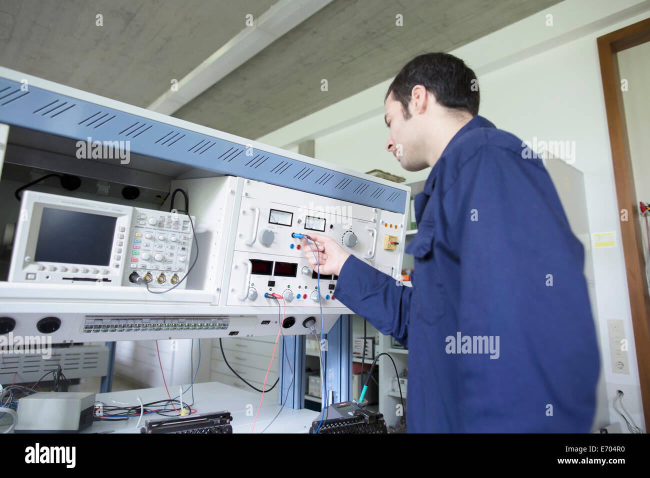 Male electrician testing control panel in workshop Stock Photo - Alamy