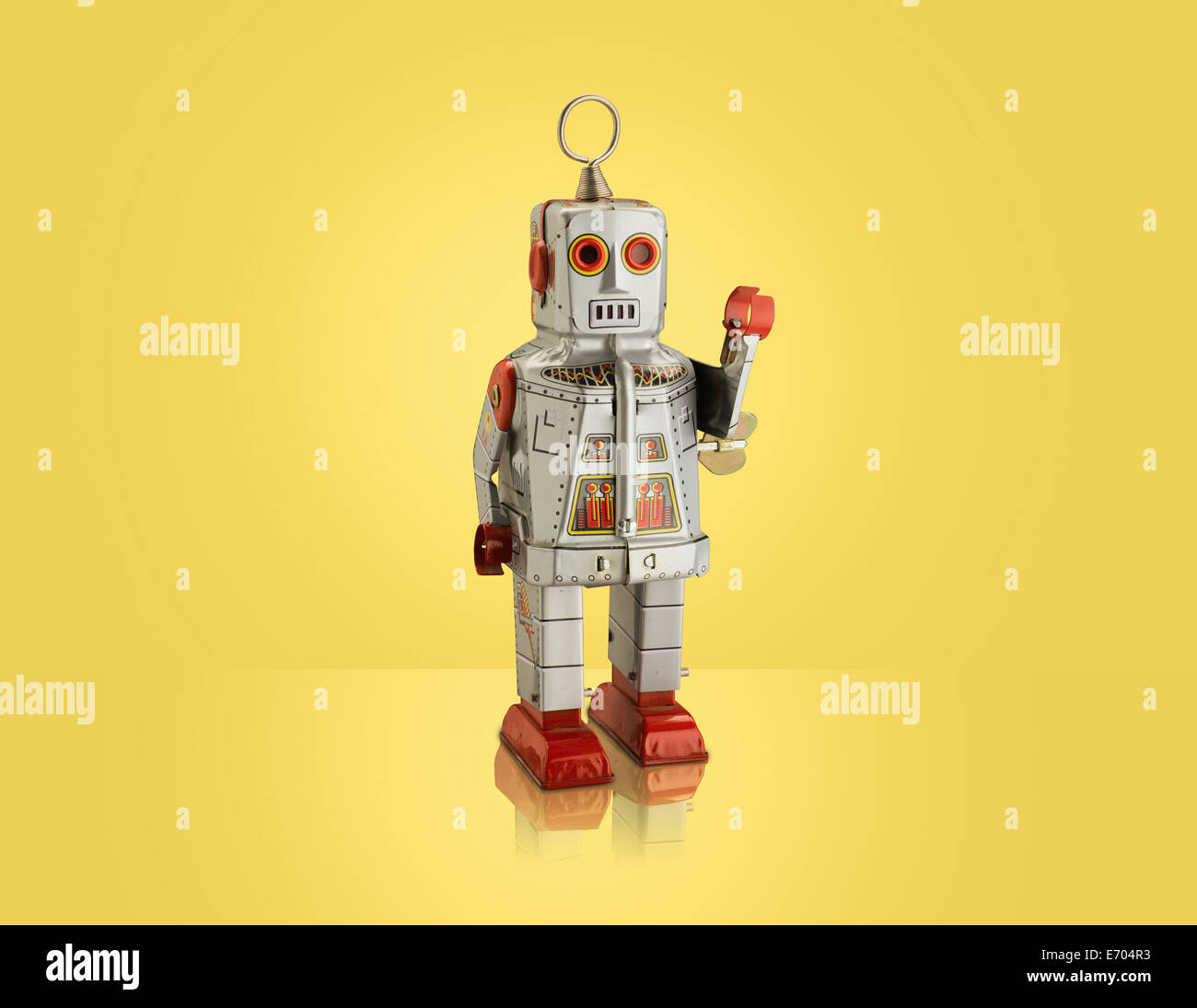 Studio shot of silver robot with arm raised Stock Photo - Alamy