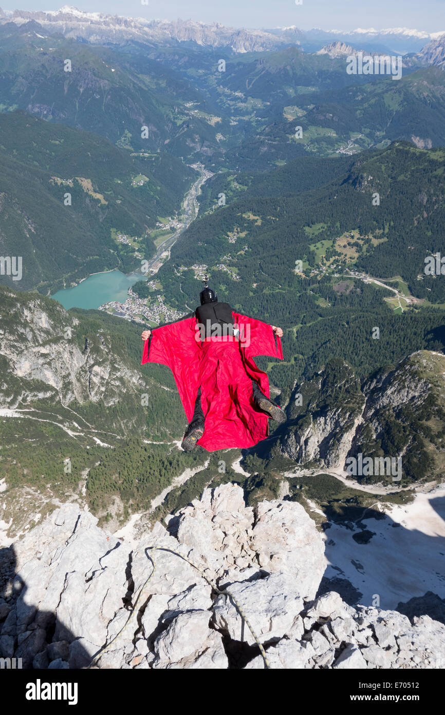 Mature man BASE jumping from mountain, Alleghe, Dolomites, Italy Stock ...