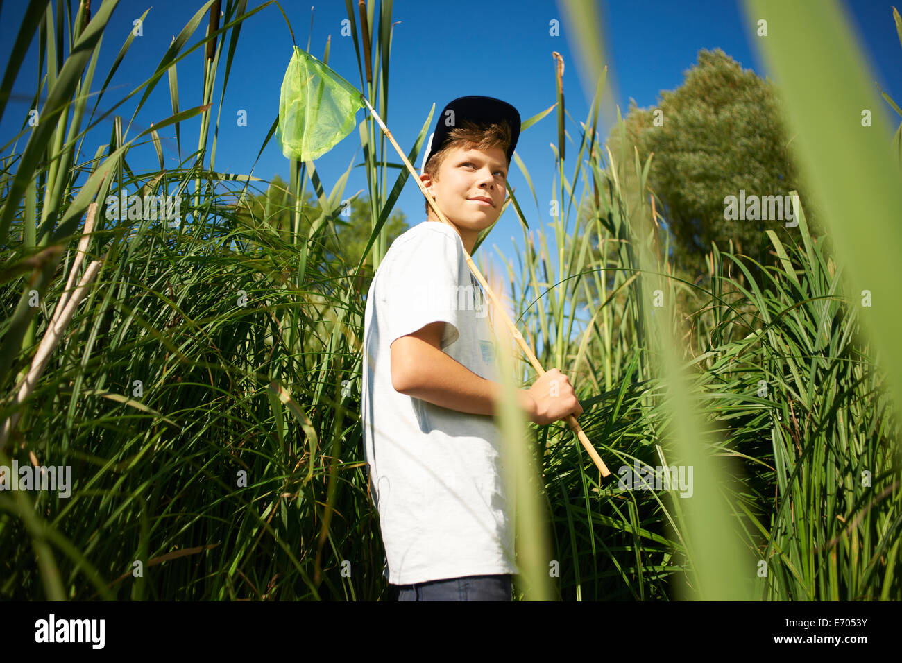 Boy holding fishing net Stock Photo - Alamy