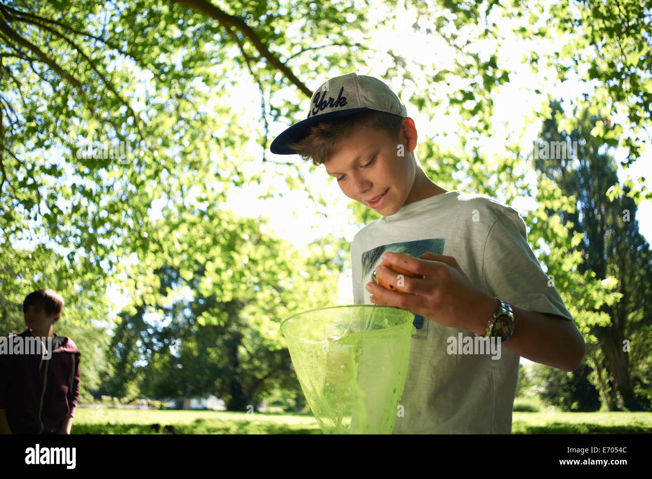 Teenage boy holding fishing net Stock Photo - Alamy