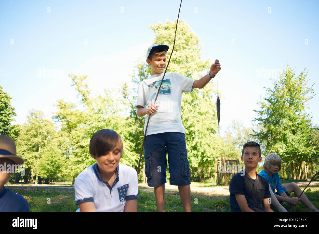 Boy holding fishing net with fish Stock Photo - Alamy