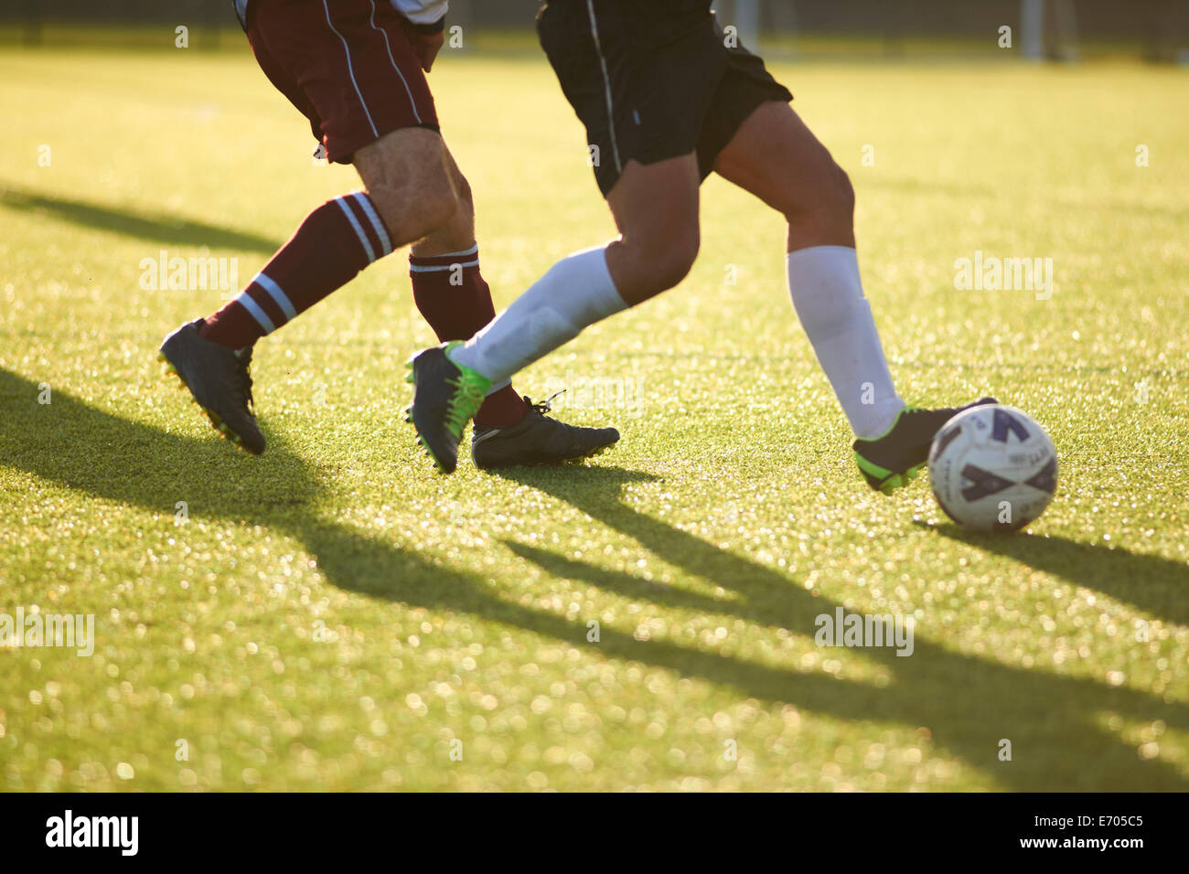Two football player fighting for ball at stadium hi-res stock ...