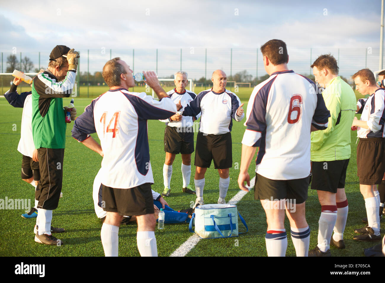 Football players resting and hydrating at half time Stock Photo - Alamy