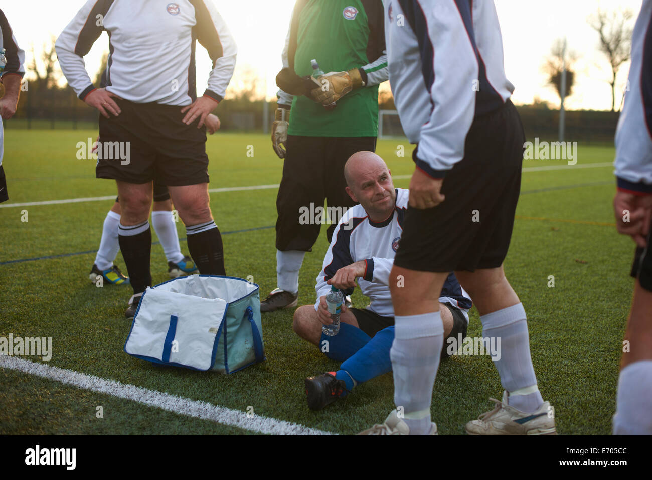 Football players resting and hydrating at half time Stock Photo - Alamy