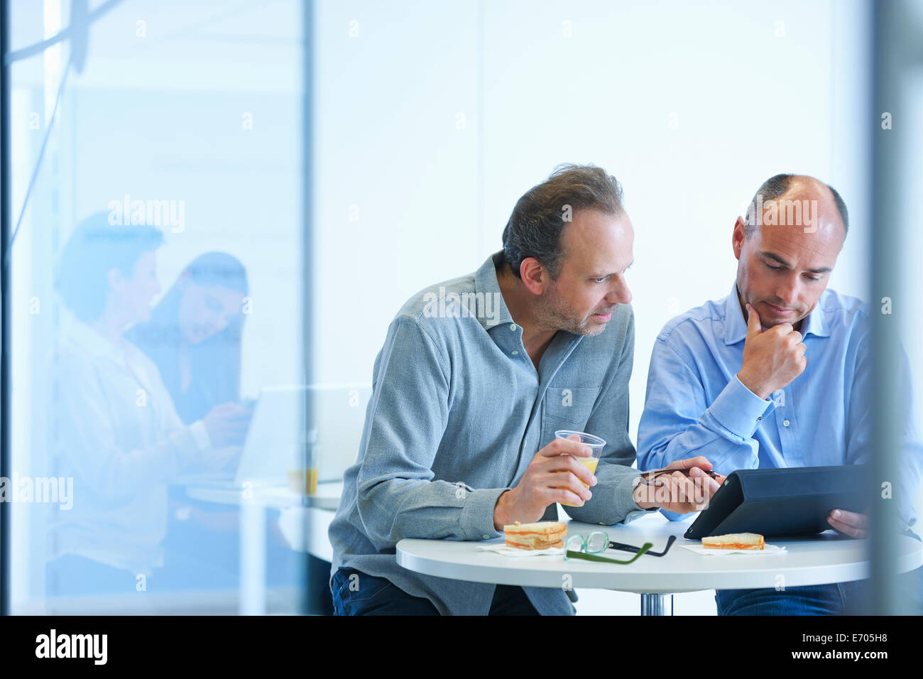 Business people having discussion over lunch Stock Photo - Alamy