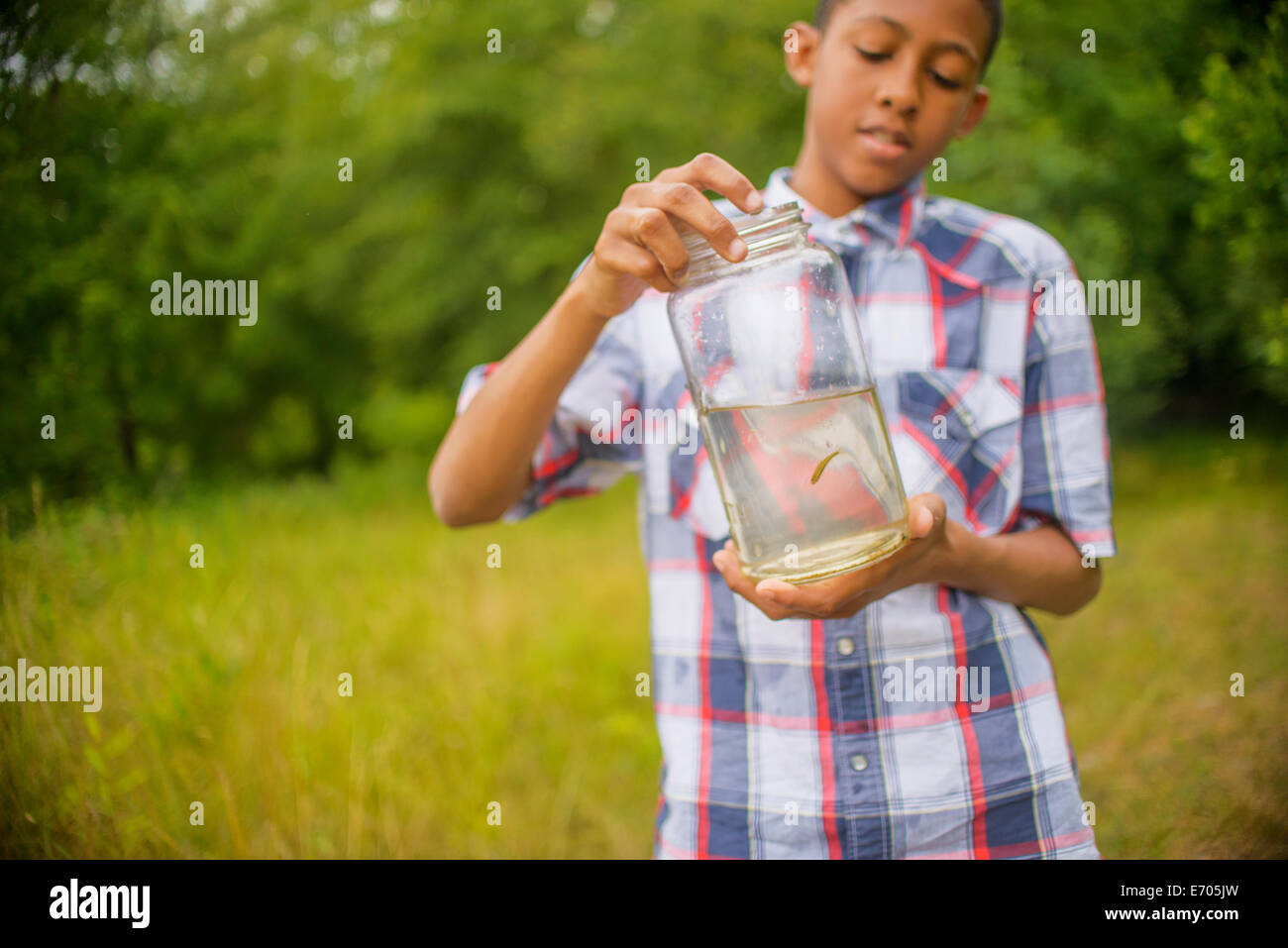 Teenage boy with fish in jar Stock Photo - Alamy