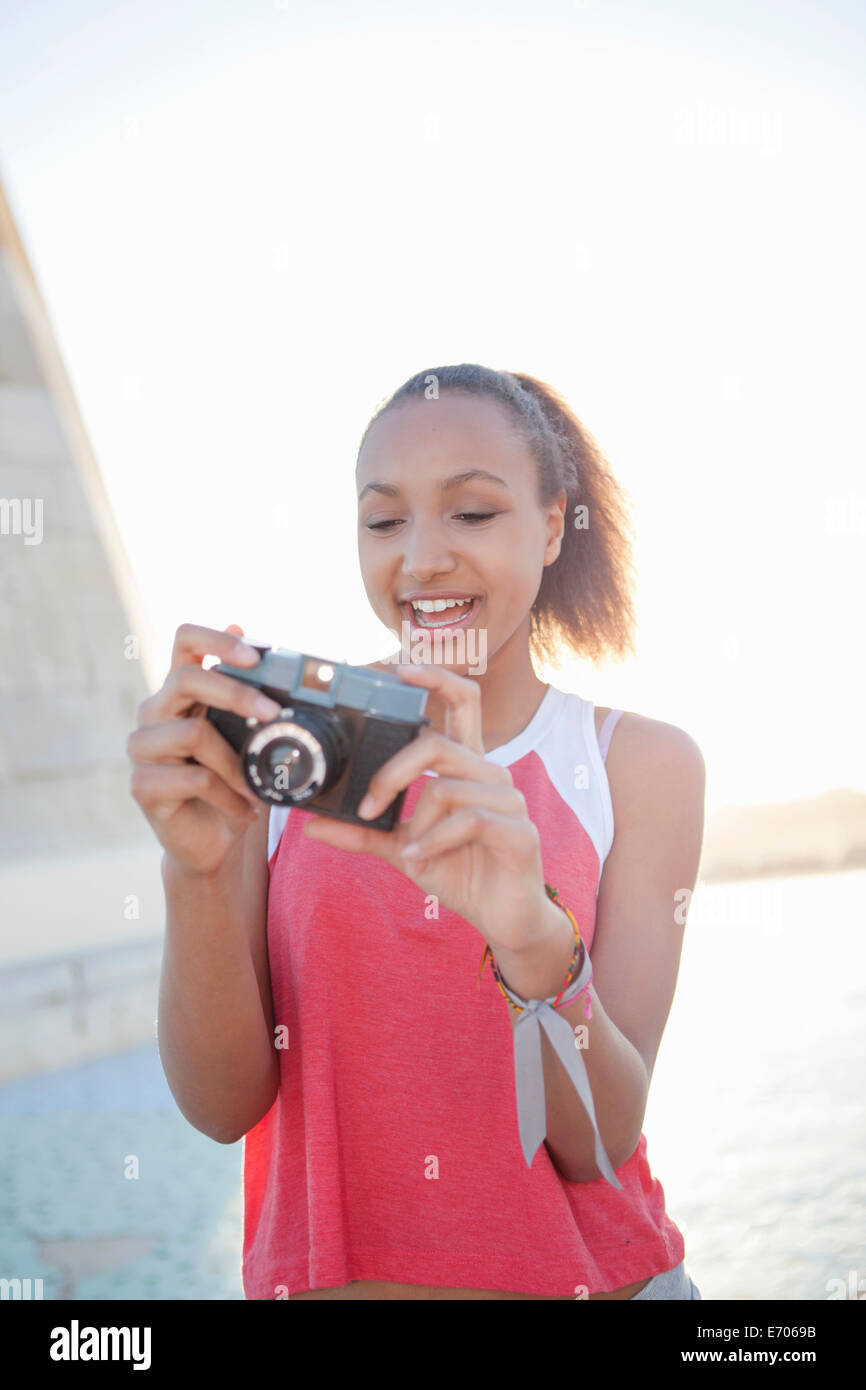 Teenage girl preparing camera Stock Photo - Alamy
