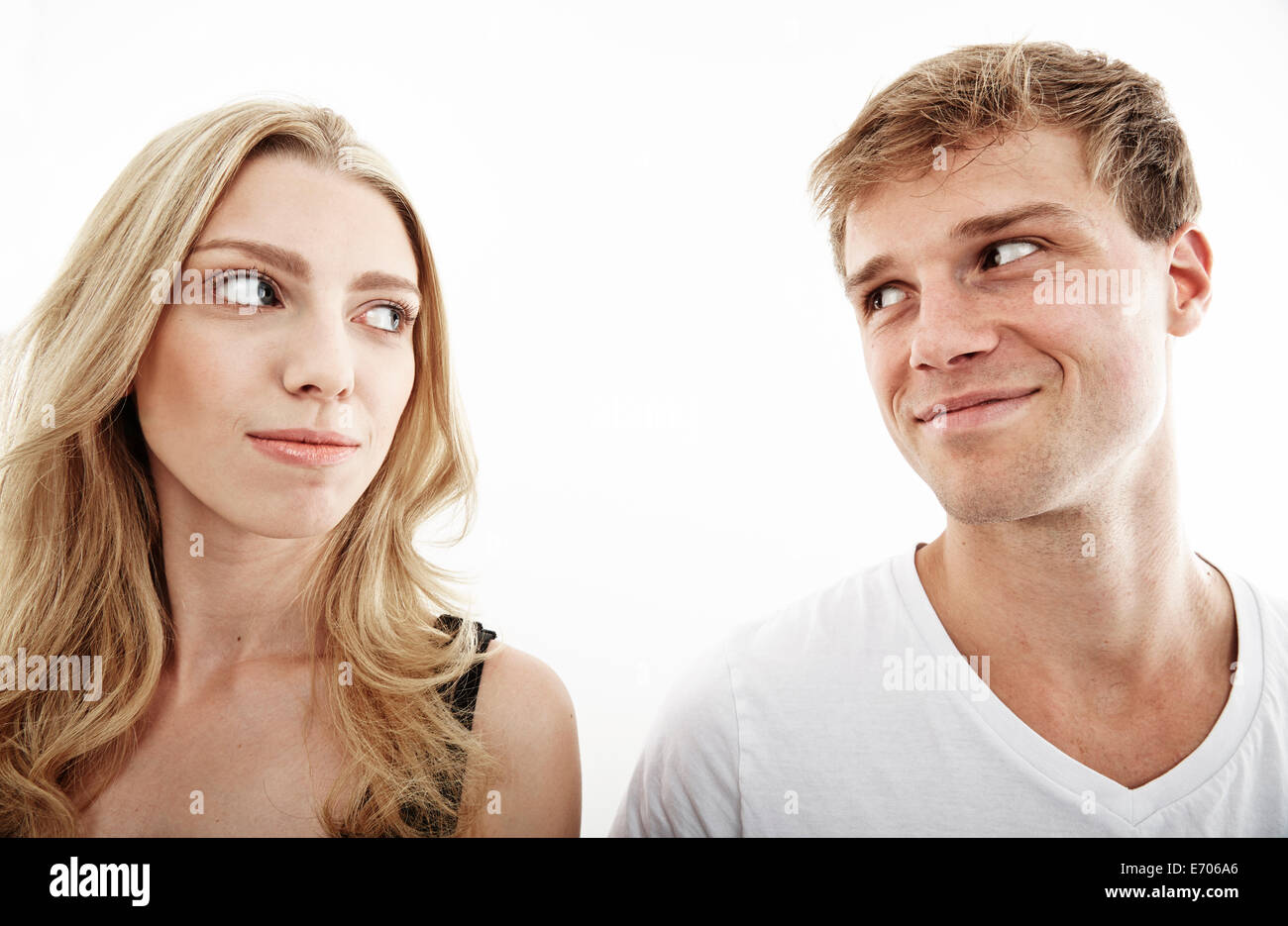 Studio portrait of young couple looking sideways at each other Stock ...