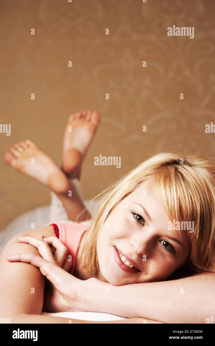Teenage girl lying on front, portrait Stock Photo - Alamy