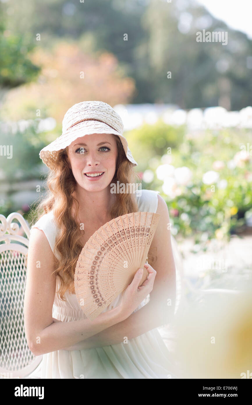Young woman with hand fan Stock Photo - Alamy