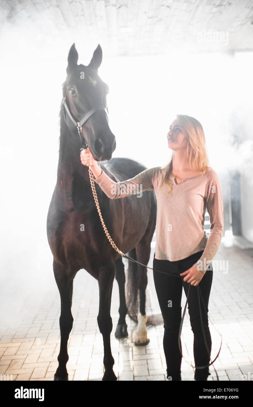 Woman in stables hi-res stock photography and images - Alamy