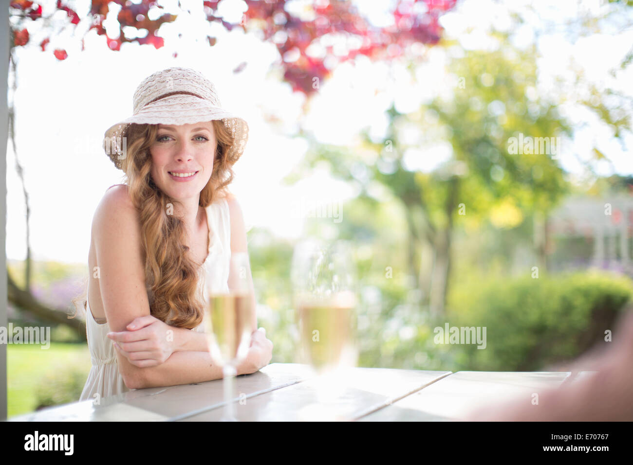 Portrait of beautiful young woman at table in garden restaurant Stock ...